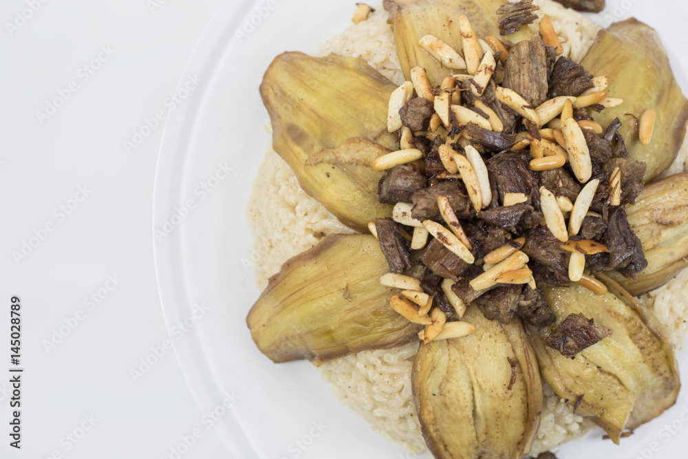 Arabic food, Biryani Rice with fried eggplant slices over it, adorned ...