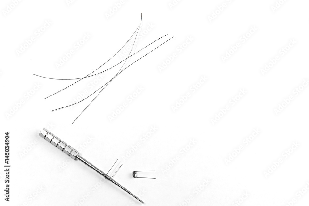 micro coil jig with cut kantola pieces and two coils on white ...