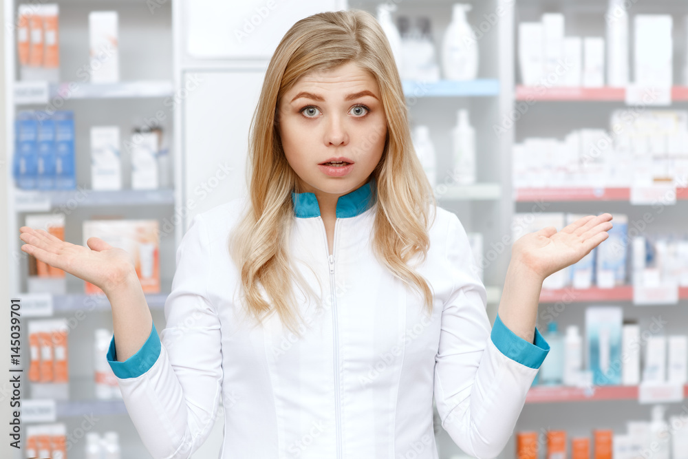Confused female pharmacist posing at the drugstore Stock Photo | Adobe ...