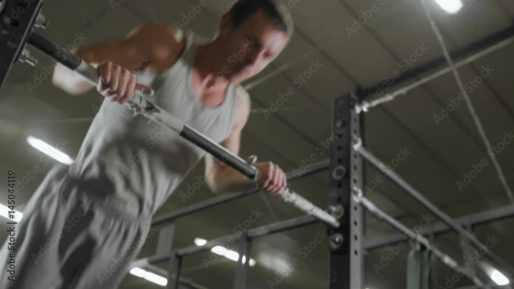 Male man athlete working out his muscles on rings, crossfit acrobat ...