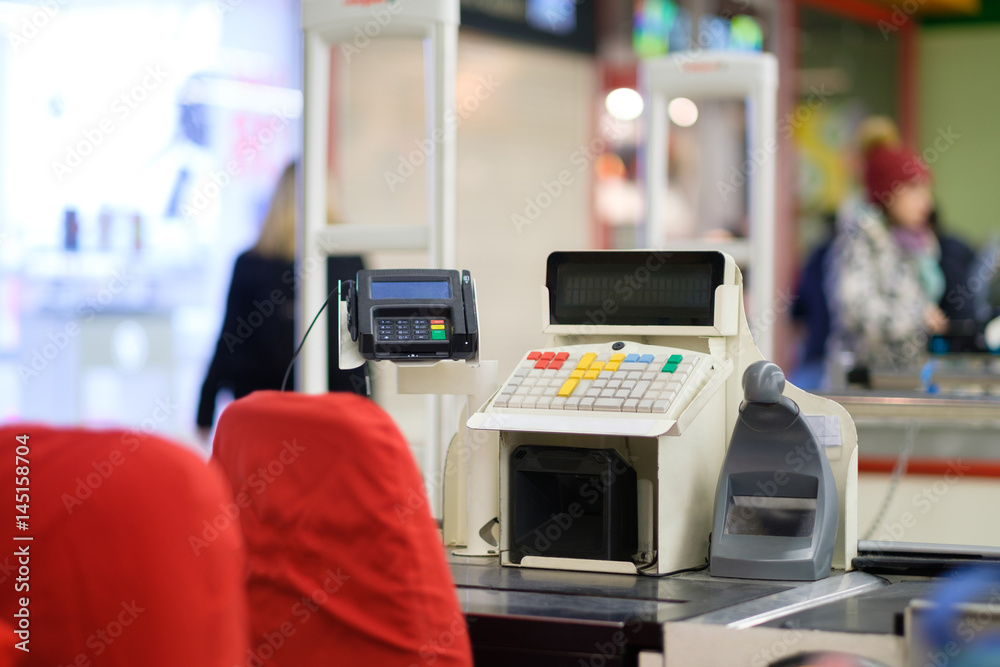 Empty cash desk with screens and card payment terminal on blurry ...