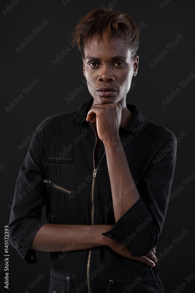 Androgynous man posing with hand on his chin Stock Photo | Adobe Stock