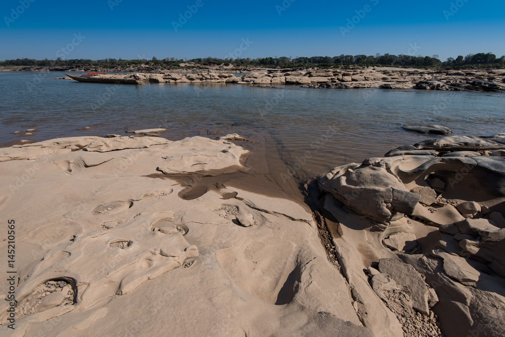 Water erosion and tidal forces showing rock formations formed by water ...