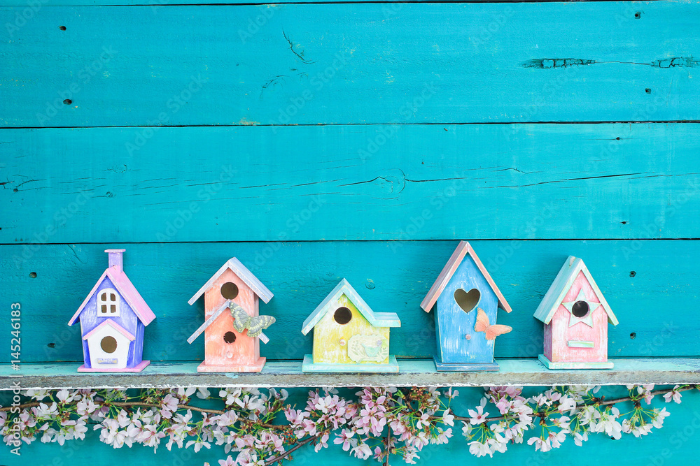 Row of colorful birdhouses with floral border Stock Photo | Adobe Stock