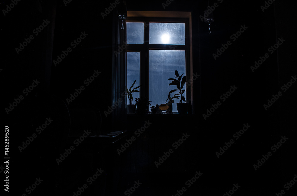 Night scene of moon seen through the window from dark room Stock Photo ...