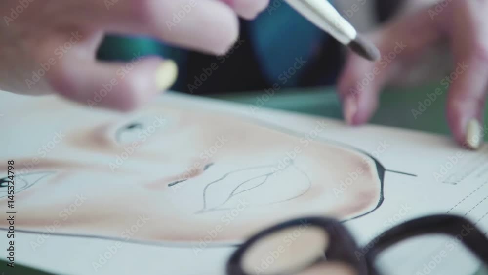 Make-up artist creates a make-up sketch on the face chart. Inspiration ...