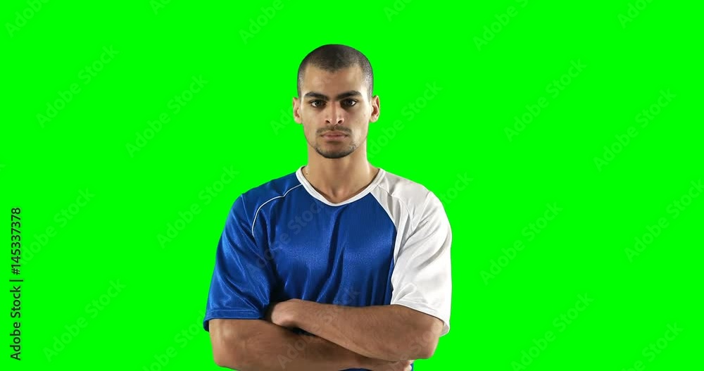 Confident football player standing against green screen Stock Video ...