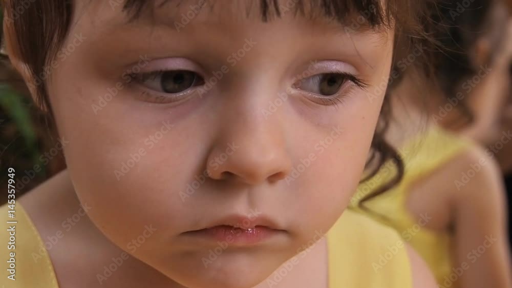 Emotions of the child. A little girl with big eyes is crying. A child ...