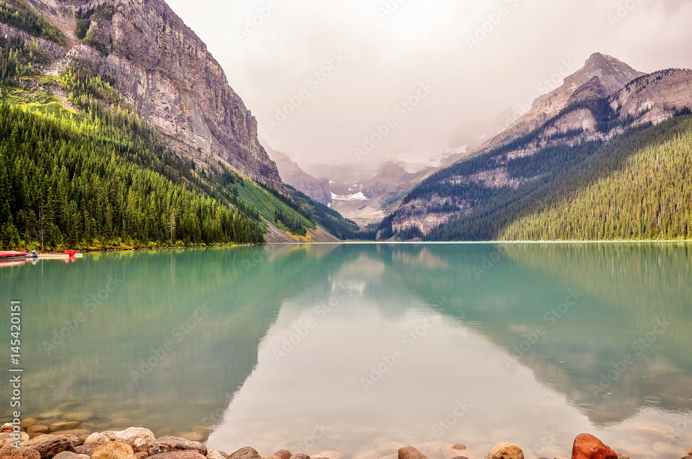 Rain starts at Lake Louise, one of the most beautiful alpine lakes in ...