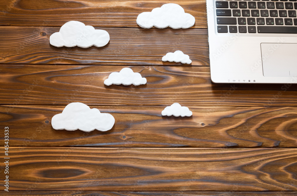Cloud computing concept laptop close up with white clouds coming out of ...
