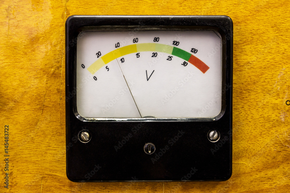 Old measuring instrument with an arrow. The instrument has a color ...