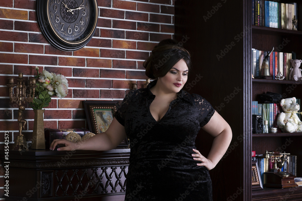 Plus size fashion model in black evening dress, fat woman on luxury ...