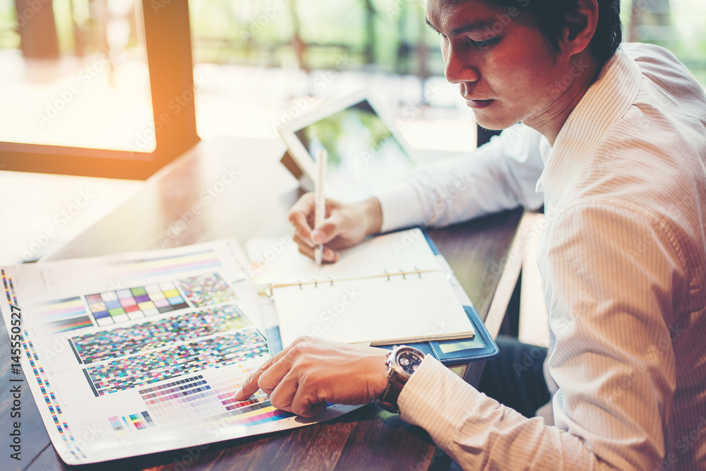 designer man working graphic with color chart and write short note for ...