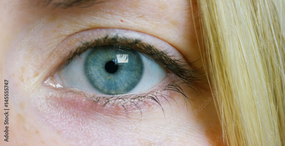 A young beautiful girl with big green-gray eyes, blonde straight hair ...