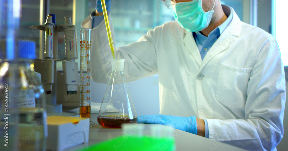 nice young scientist male doctor analyzing liquids virus cells in ...