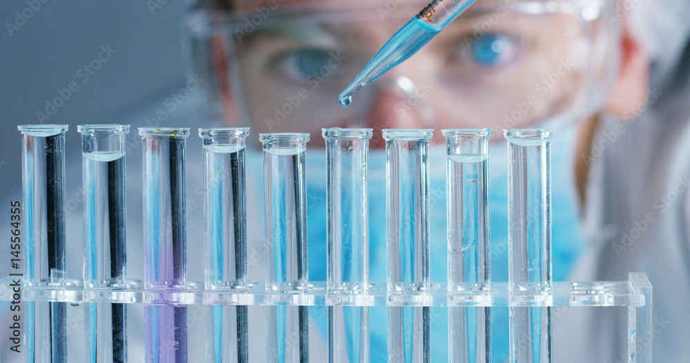 Close up of a scientist with futuristic graphics with which scans and ...