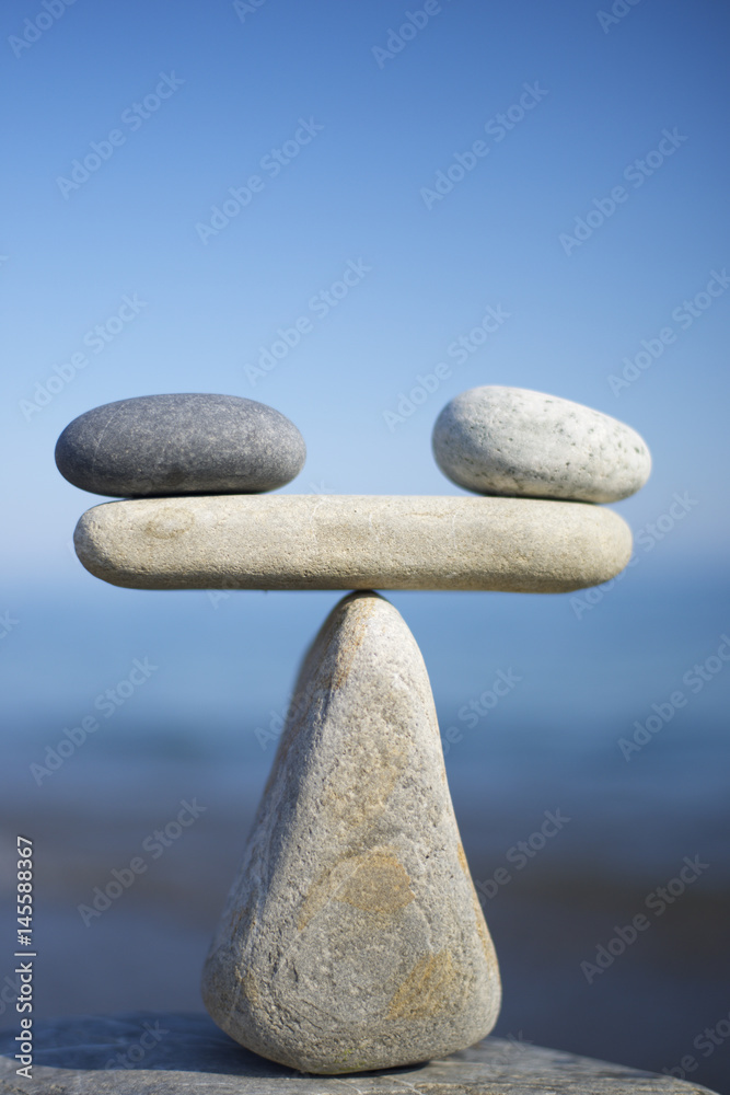 Balancing of black and white pebbles on the top of stone. Symbol of ...