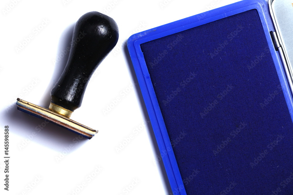 Old and vintage stamper with wooden handle put beside blue color inkpad ...