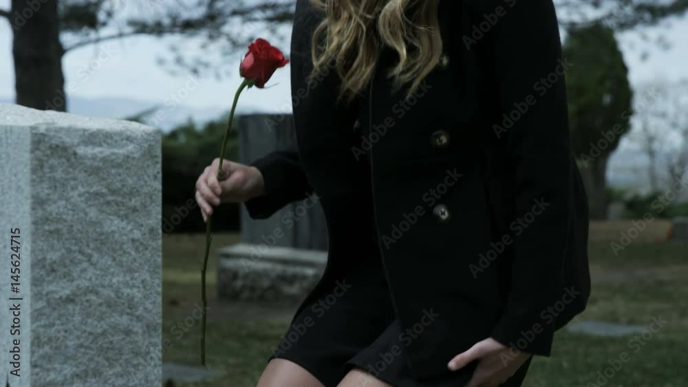 slow motion girl leaving rose on grave stone in cemetary Stock Video ...