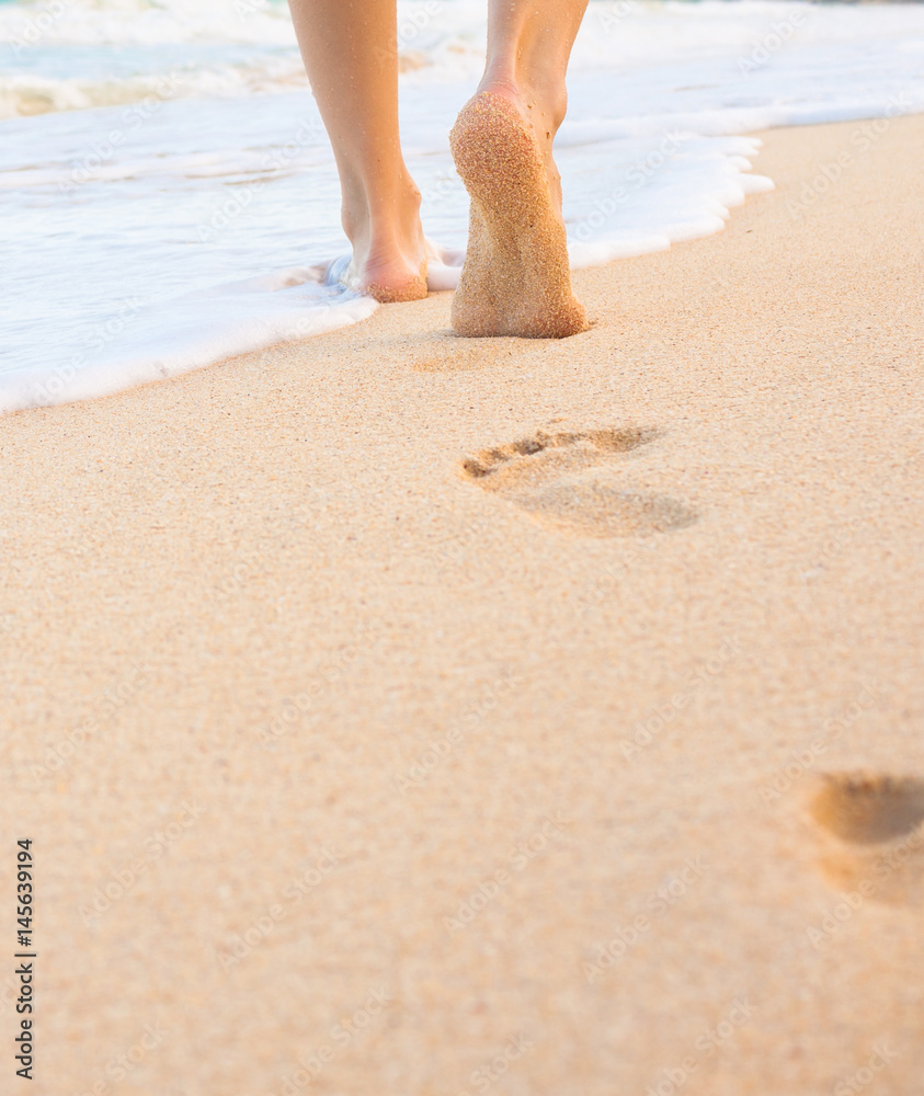 Feet walking on the beach leaving footprints in the sand. Stock Photo ...