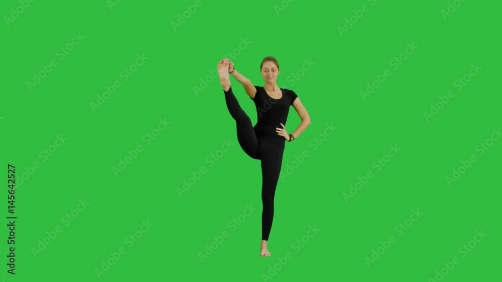 Athletic girl standing in yoga asana utthita hasta Padangustasana ...