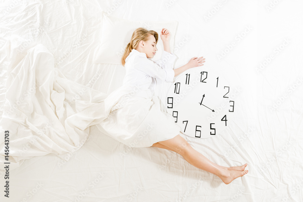 Expressive woman sleeping. Full length high angle view of a young woman ...