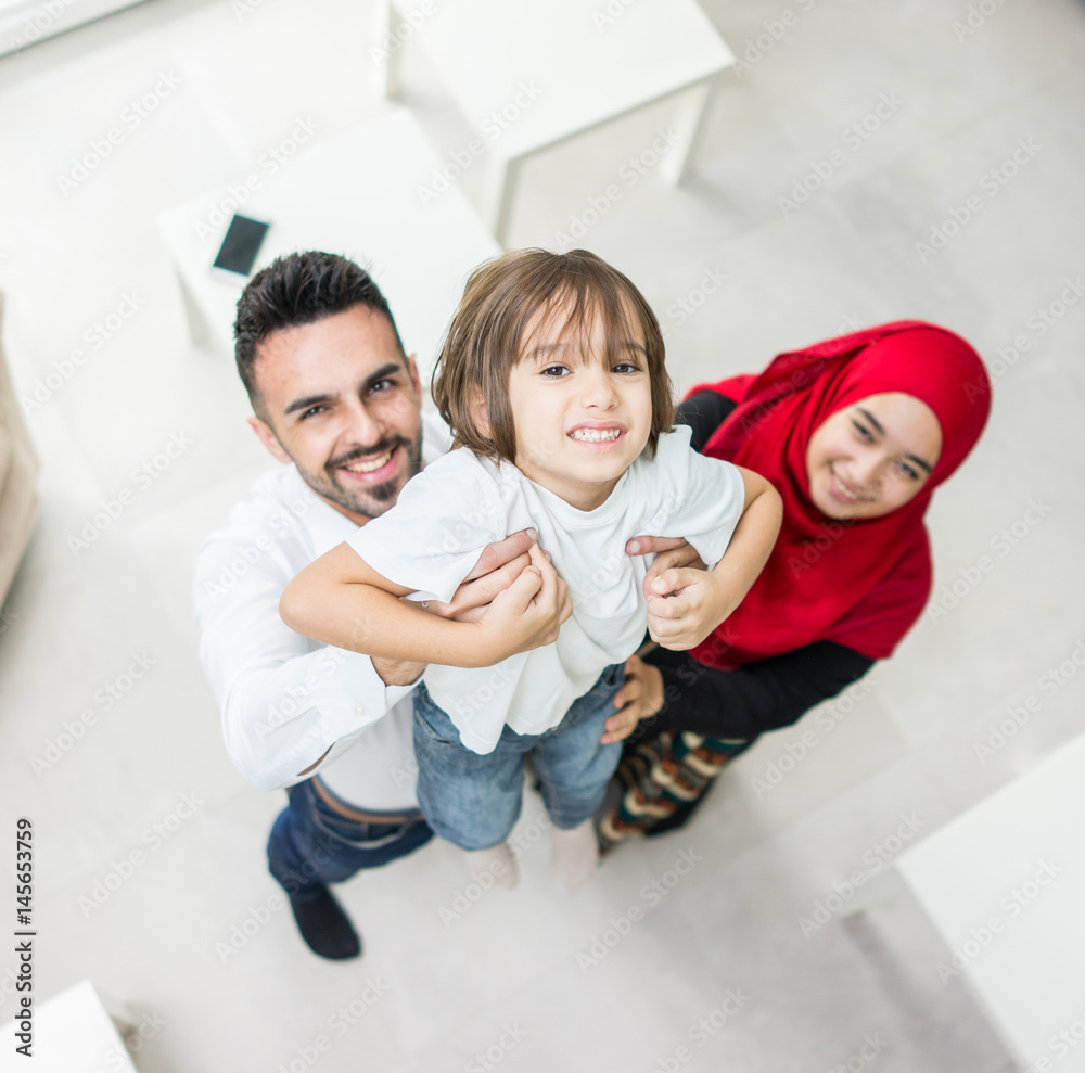 Happy Muslim family at modern home having fun and good time together ...