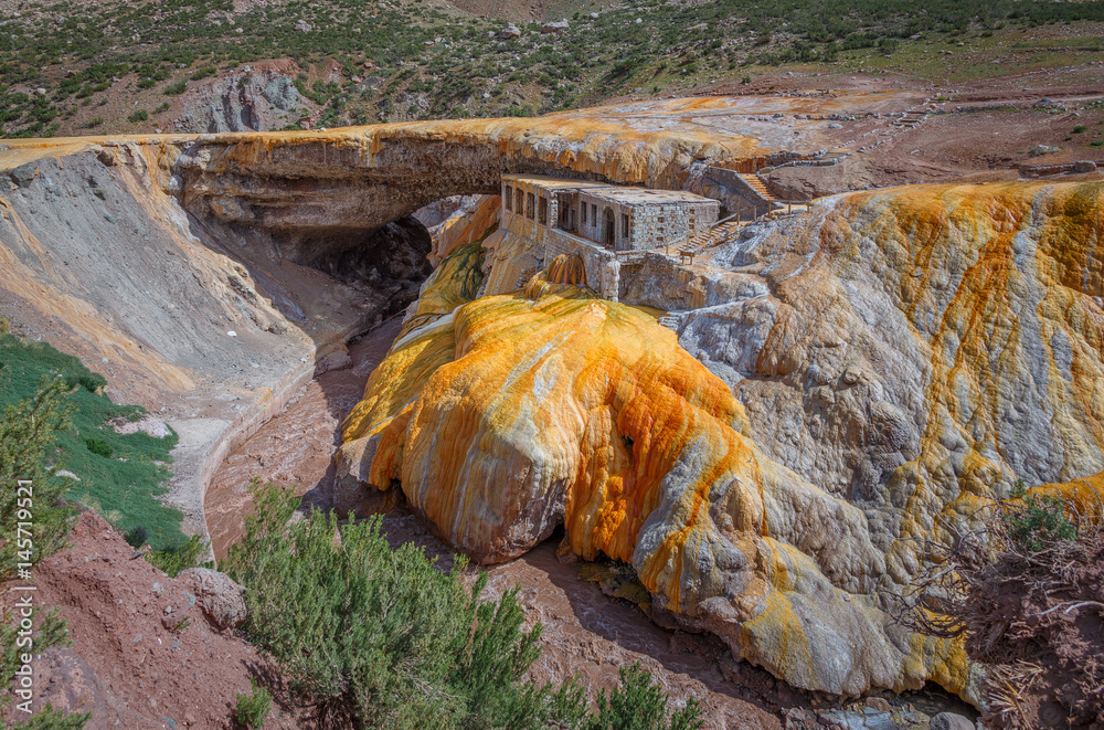 Thermal hotel ruins. The Incas Bridge is a natural colorful arch that ...