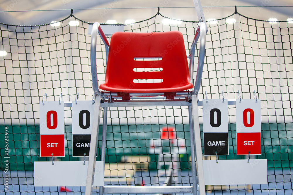 Umpire chair with scoreboard on a tennis court before the game. Stock ...