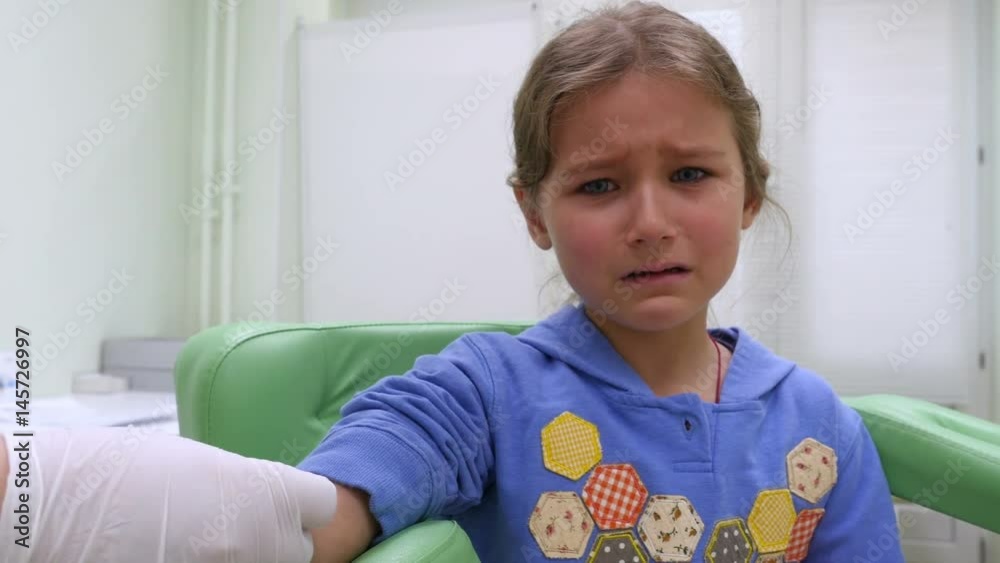 Blood test, little girl sitting on medical chair while nurse taking her ...