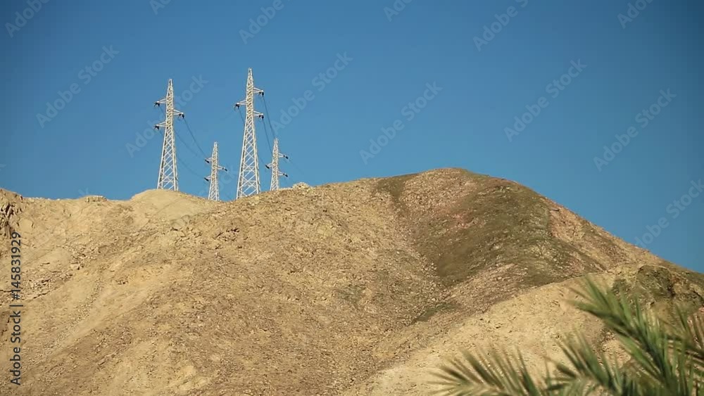 Overhead power line on the mountain. Power transmission towers Stock ...
