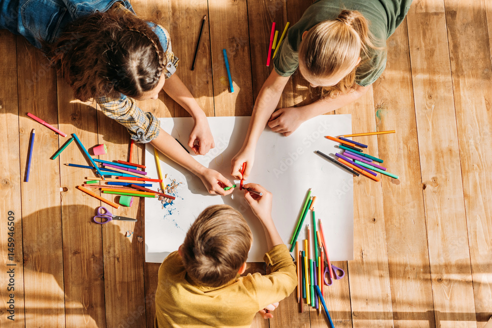 cute kids drawing on paper with pencils while lying on floor Stock ...