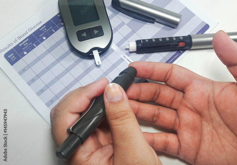 Hand doing glucose monitoring procedure using glucometer Stock Photo ...