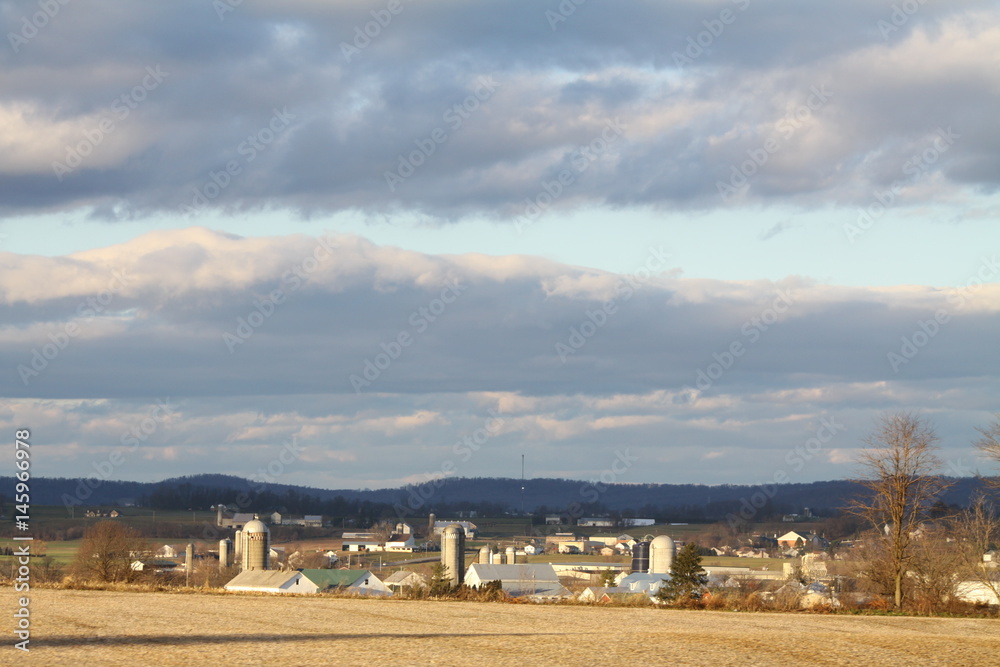 Farm buildings and Silos on a large expanse of farm land, community, on ...