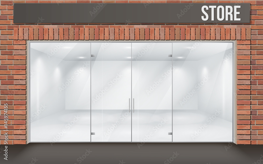 Brick facade of the store with large transparent storefronts. The empty ...