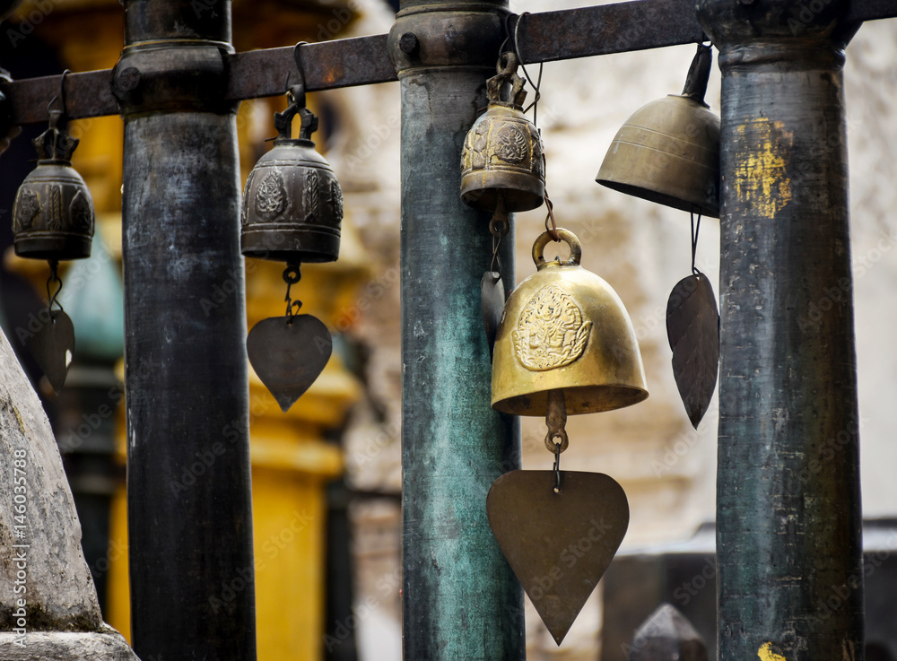 Bronze bells in temple of Thailand hanged on metal fence around the ...