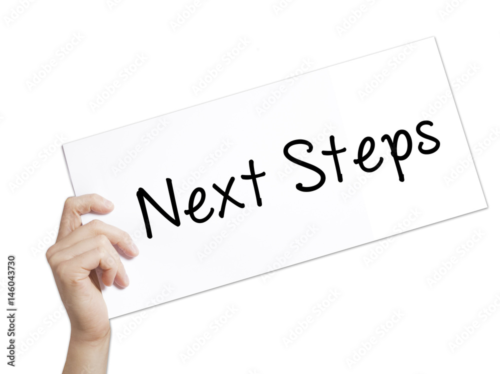 Next Steps Sign on white paper. Man Hand Holding Paper with text ...