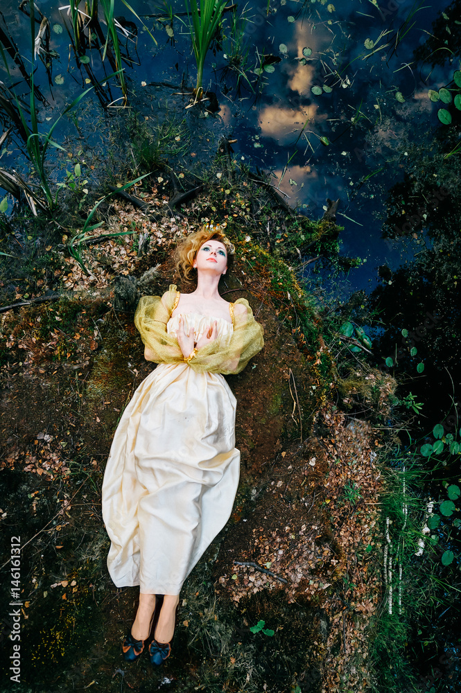 Young Russian witch faery bloat girl fish queen in fairy dress lying on ...