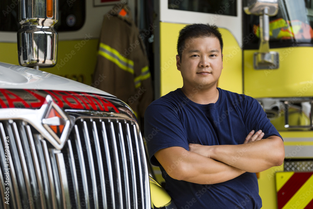 Serious Chinese fireman posing with fire truck Stock Photo | Adobe Stock