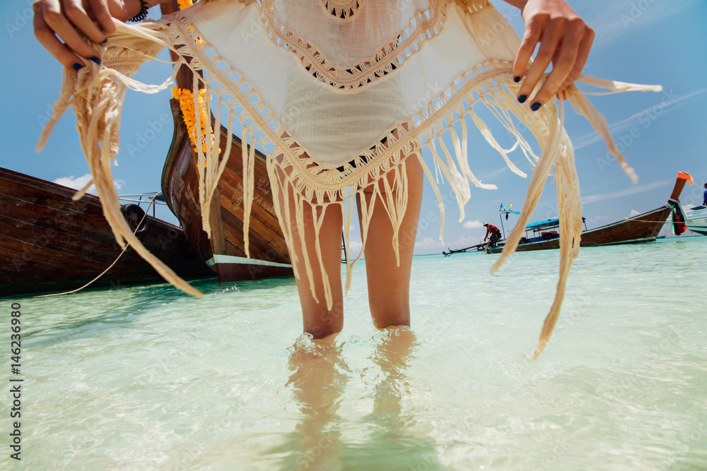 Beautiful young girl model in a swimsuit posing against a traditional ...