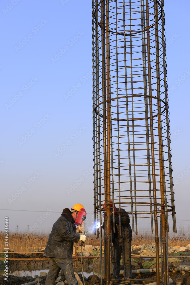 Hoisting steel bars in the construction site Stock Photo | Adobe Stock