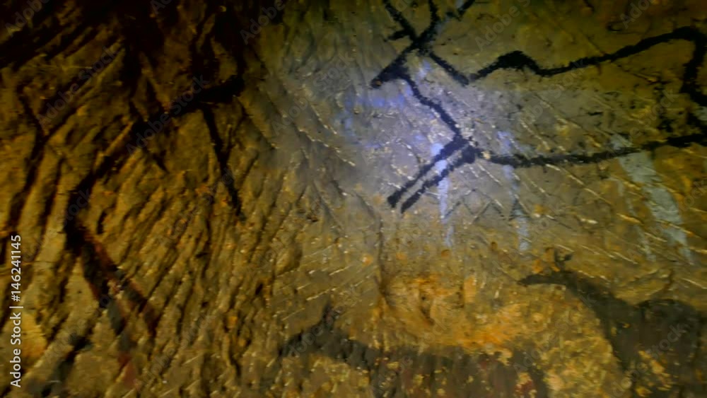Discovery of prehistoric paint of caveman hunt in sandstone cave. Paint ...