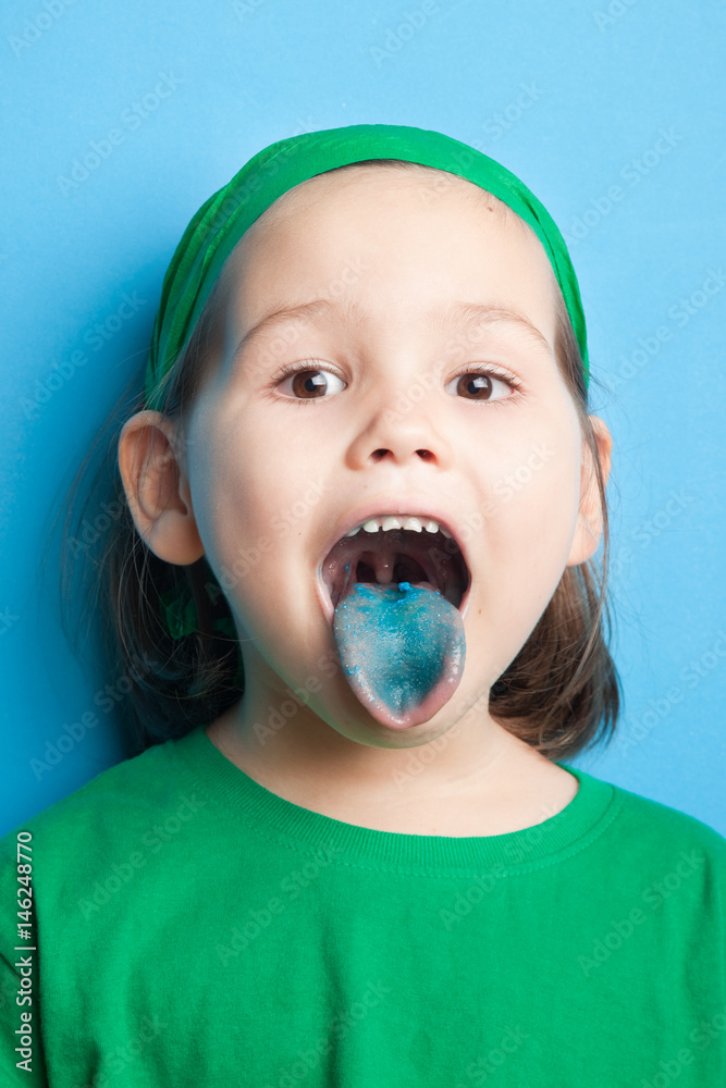 Little girl with blue tongue Stock Photo | Adobe Stock