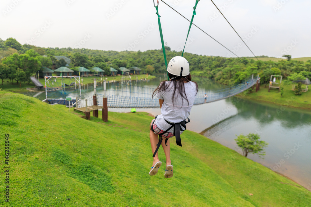 Woman sliding on a zip line adventure at Mountain lake resort in Laguna ...