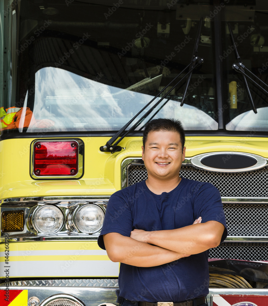 Smiling Chinese fireman posing with fire truck Stock Photo | Adobe Stock