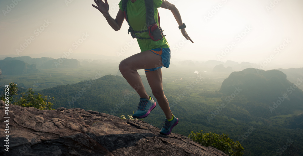 young woman trial runner running up on mountain top Stock Photo | Adobe ...