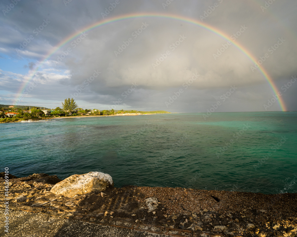Rainbow over ocean and beach Jamaica Stock Photo | Adobe Stock