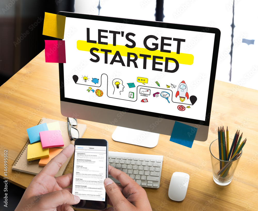 LET'S GET STARTED Two Businessman working at office desk and using a ...