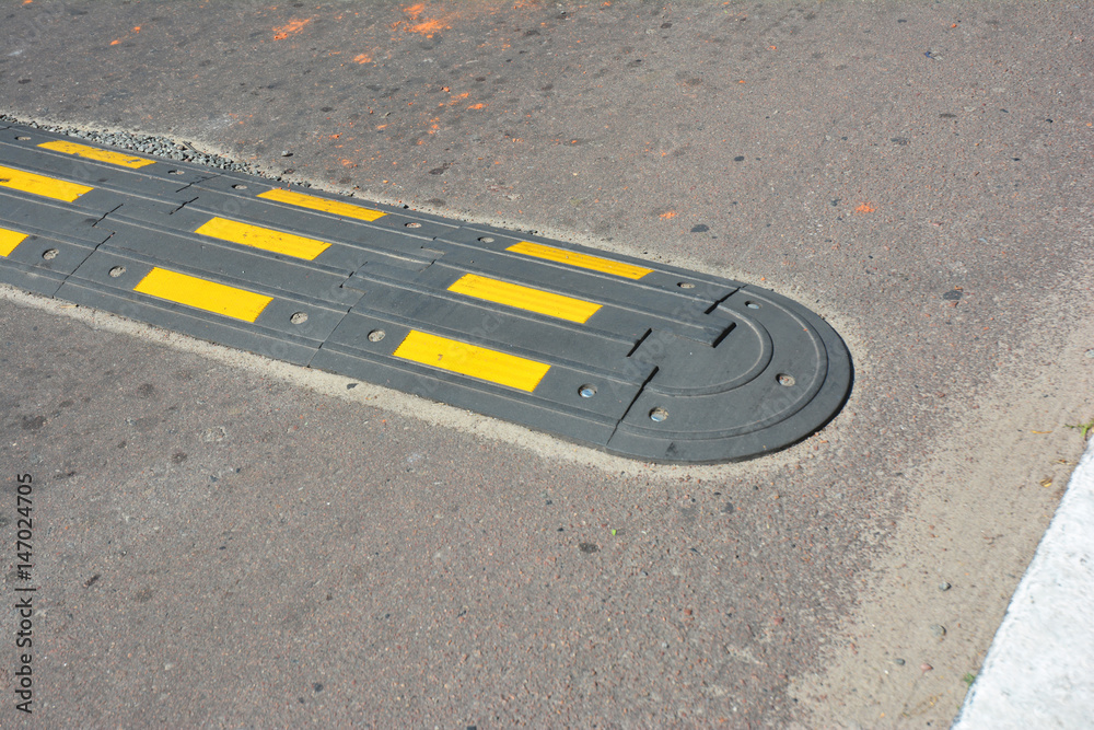 Traffic safety speed bump with crosswalk on an asphalt road. Speed ...