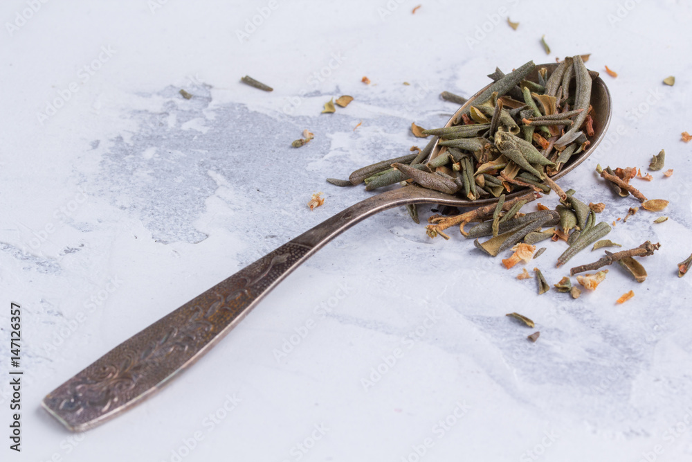 Rhododendron of Adamsia in a spoon on a white background. Dry medicinal ...